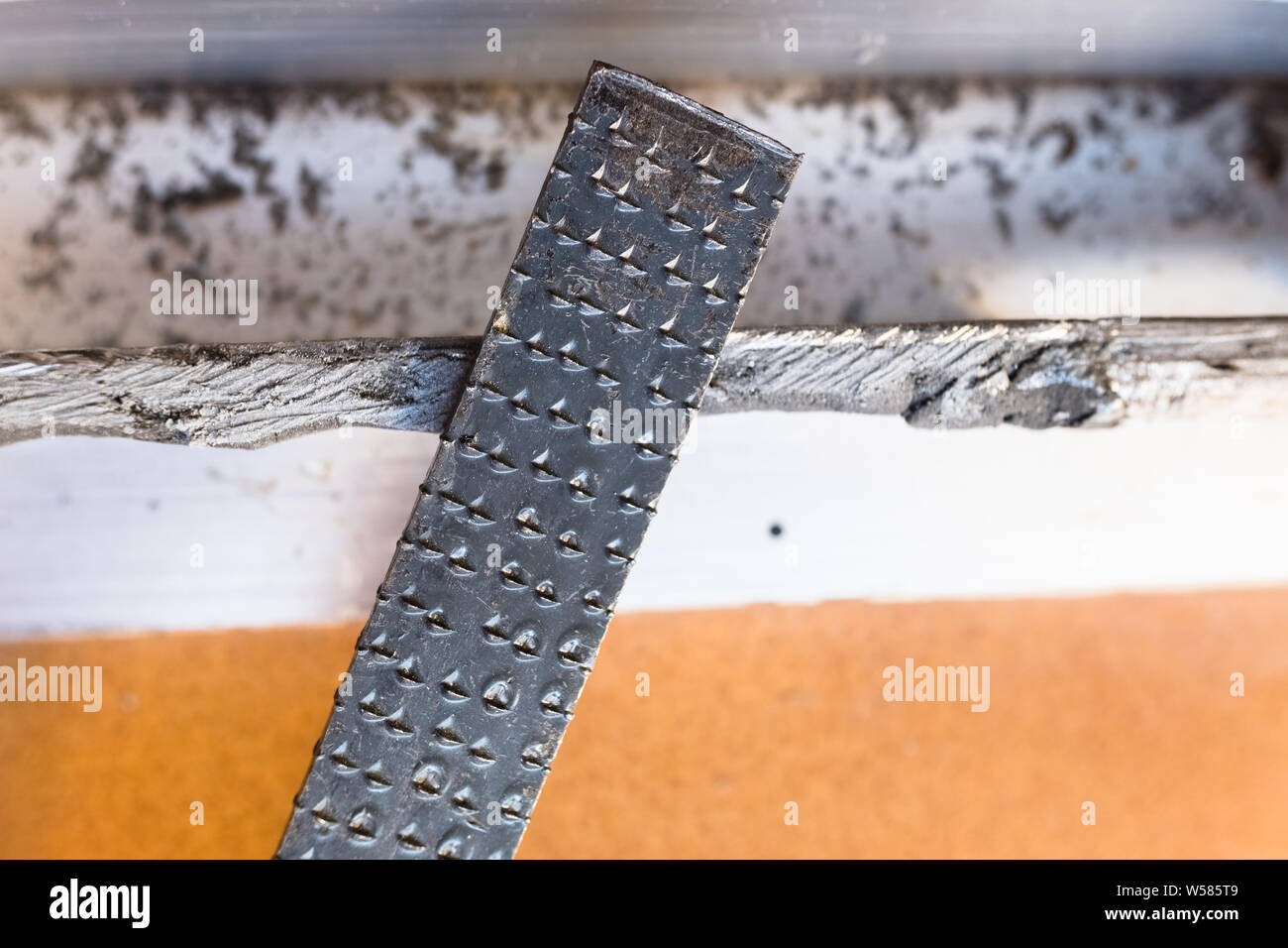 Close-up of a metal file, used to repair the aluminum frame of a window ...