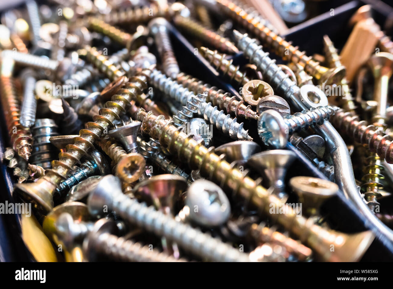 Macro of many silver and gold screws of different sizes Stock Photo - Alamy