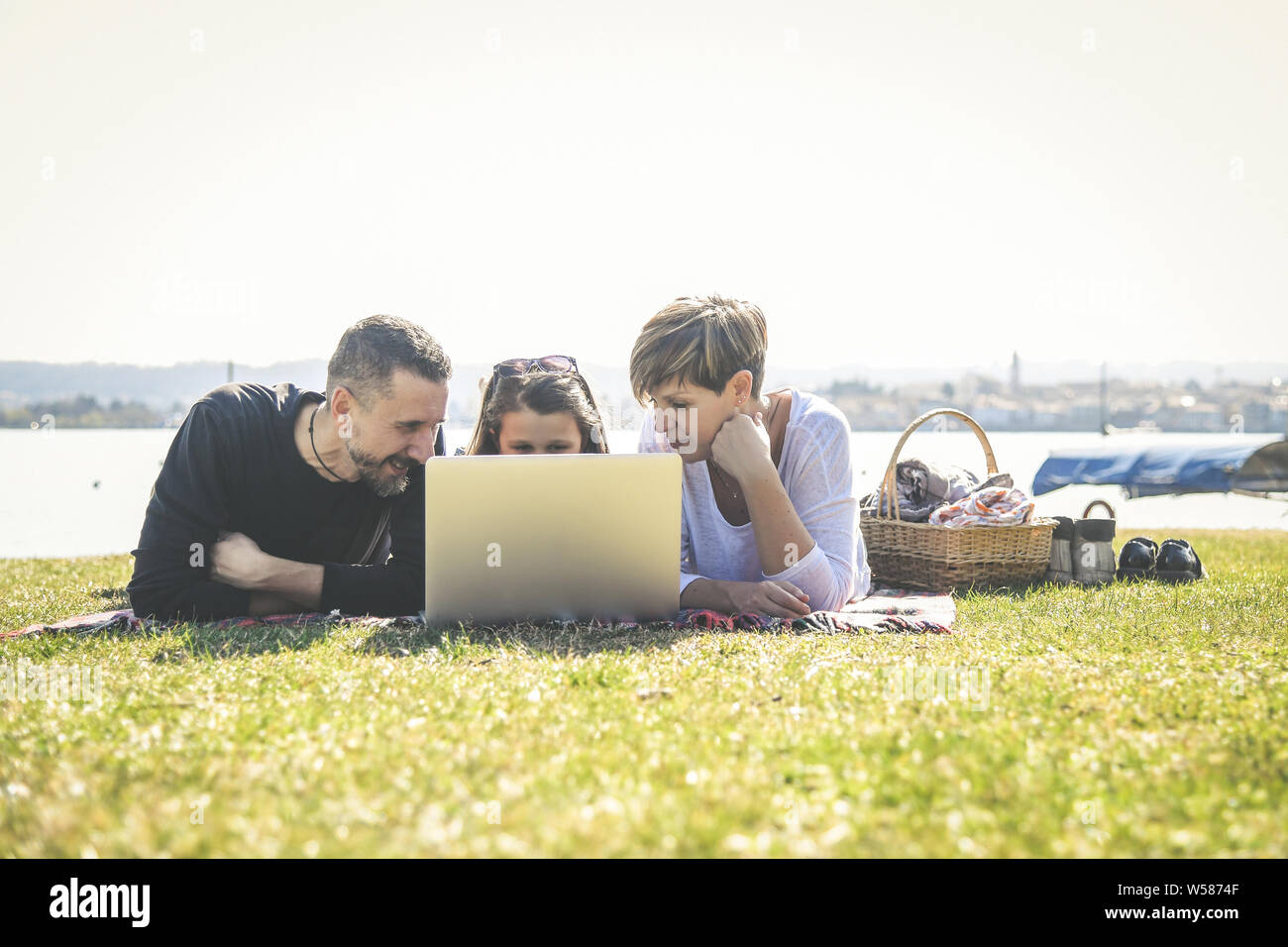Happy family using laptop computer together garden park summer. Kid ...