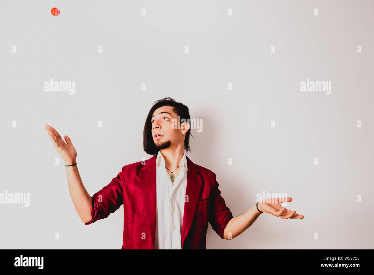 Young magician throwing dice to the air to look for luck Stock Photo ...