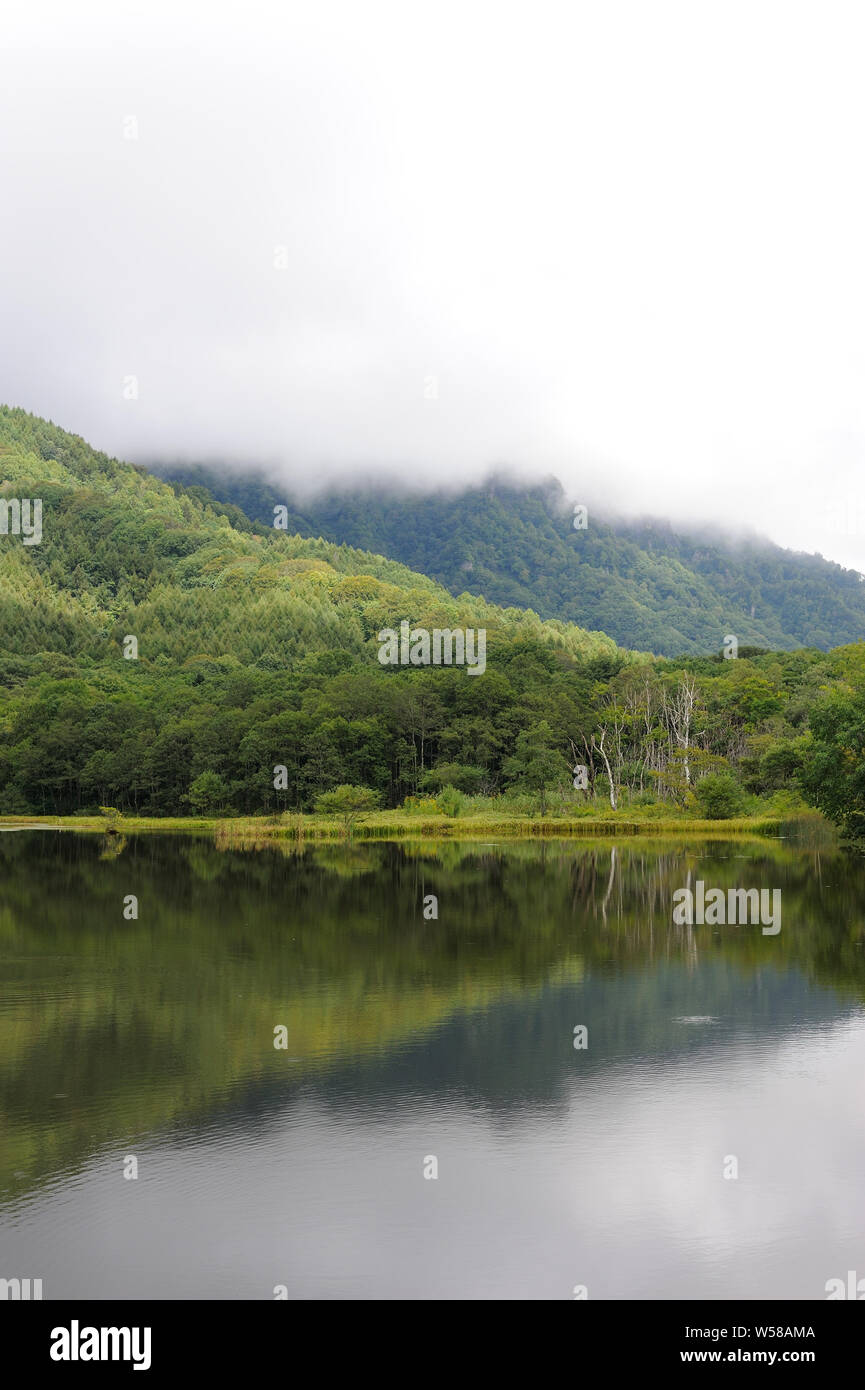 View towards mountains over Lake Kagamiike, Togakushi, Nagano, Japan ...
