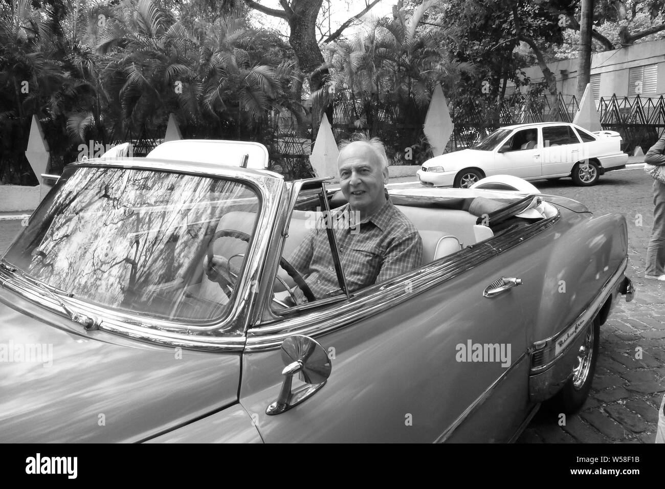 Man in American car in Havana sporty soft top classic car sitting ...