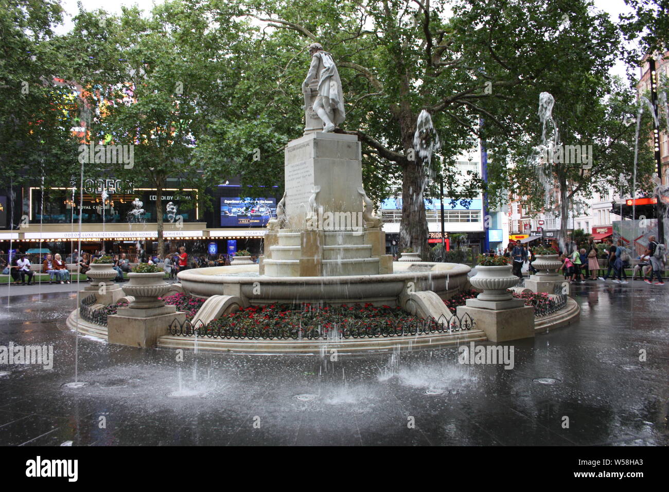 fountain with a statue in one of the largest squares with a garden in ...