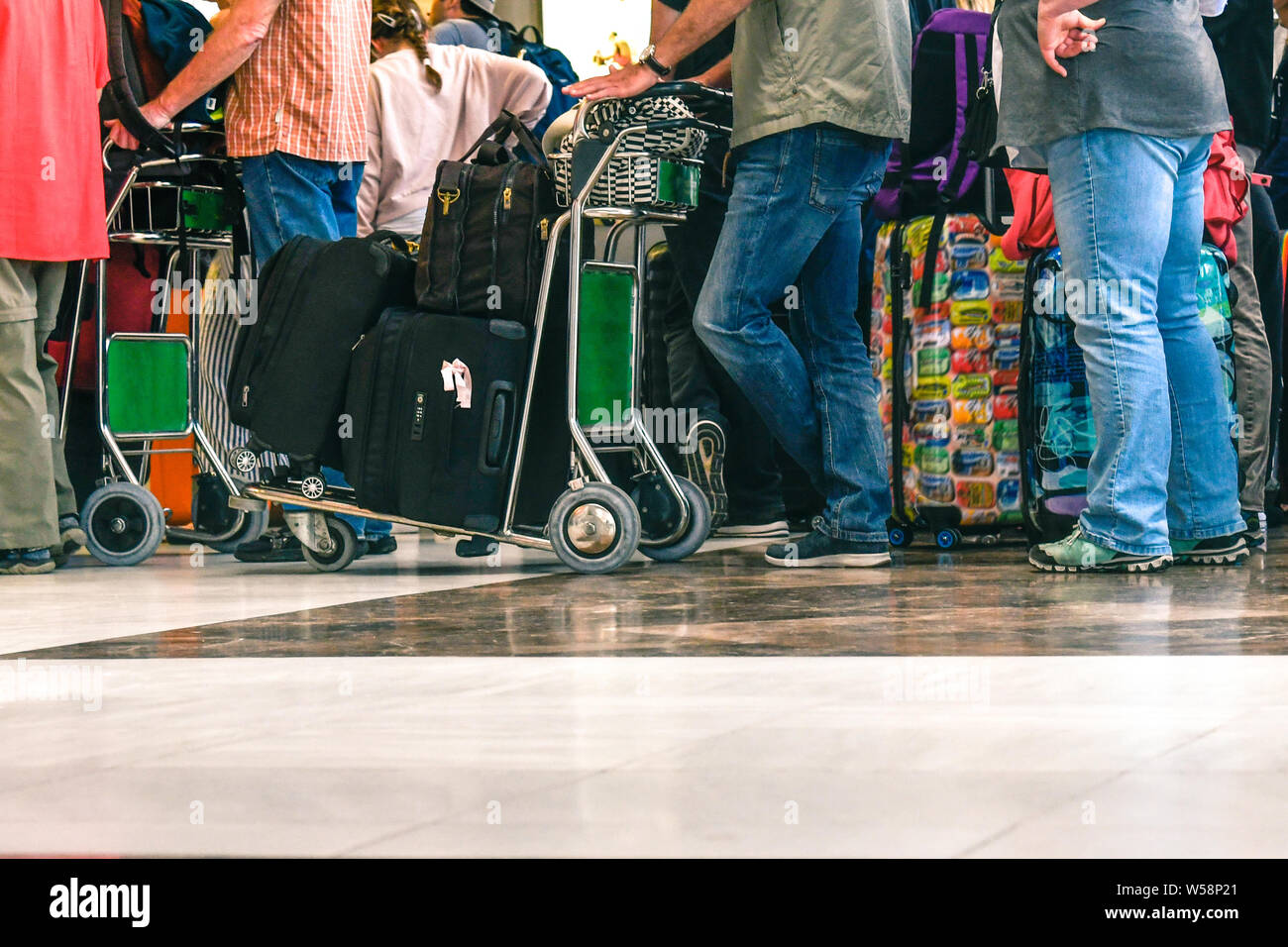 Passengers waiting in line for boarding an airport for a flight ...