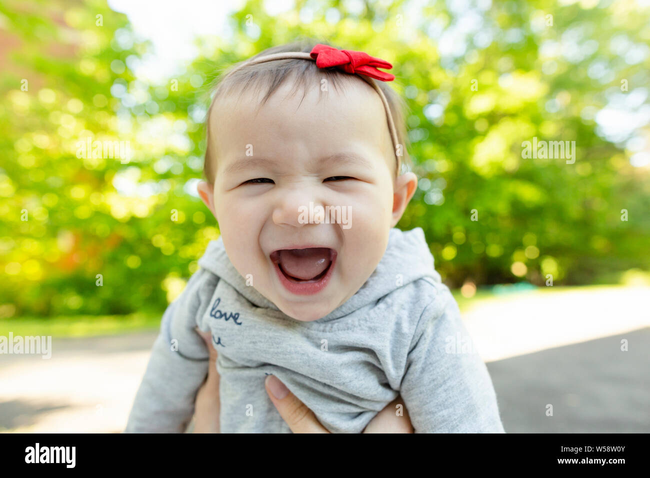 Happy girl wearing red bow hi-res stock photography and images - Alamy