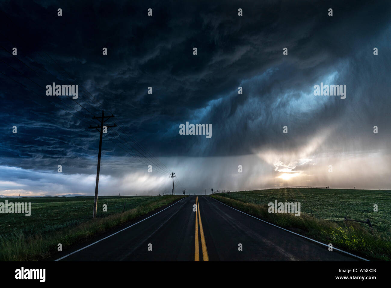 Heavy storm and rain with road and green fields Stock Photo - Alamy