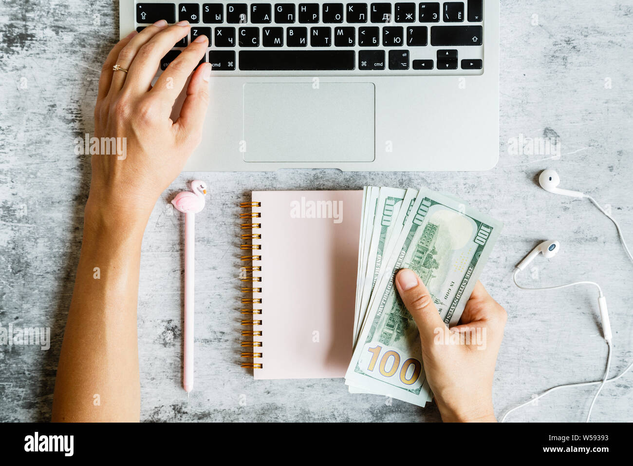 Desktop flatlay: laptop, notebook, woman hands holding pen and typing ...