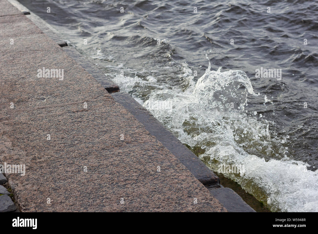 waves hit the pier background weather breakwater Stock Photo - Alamy