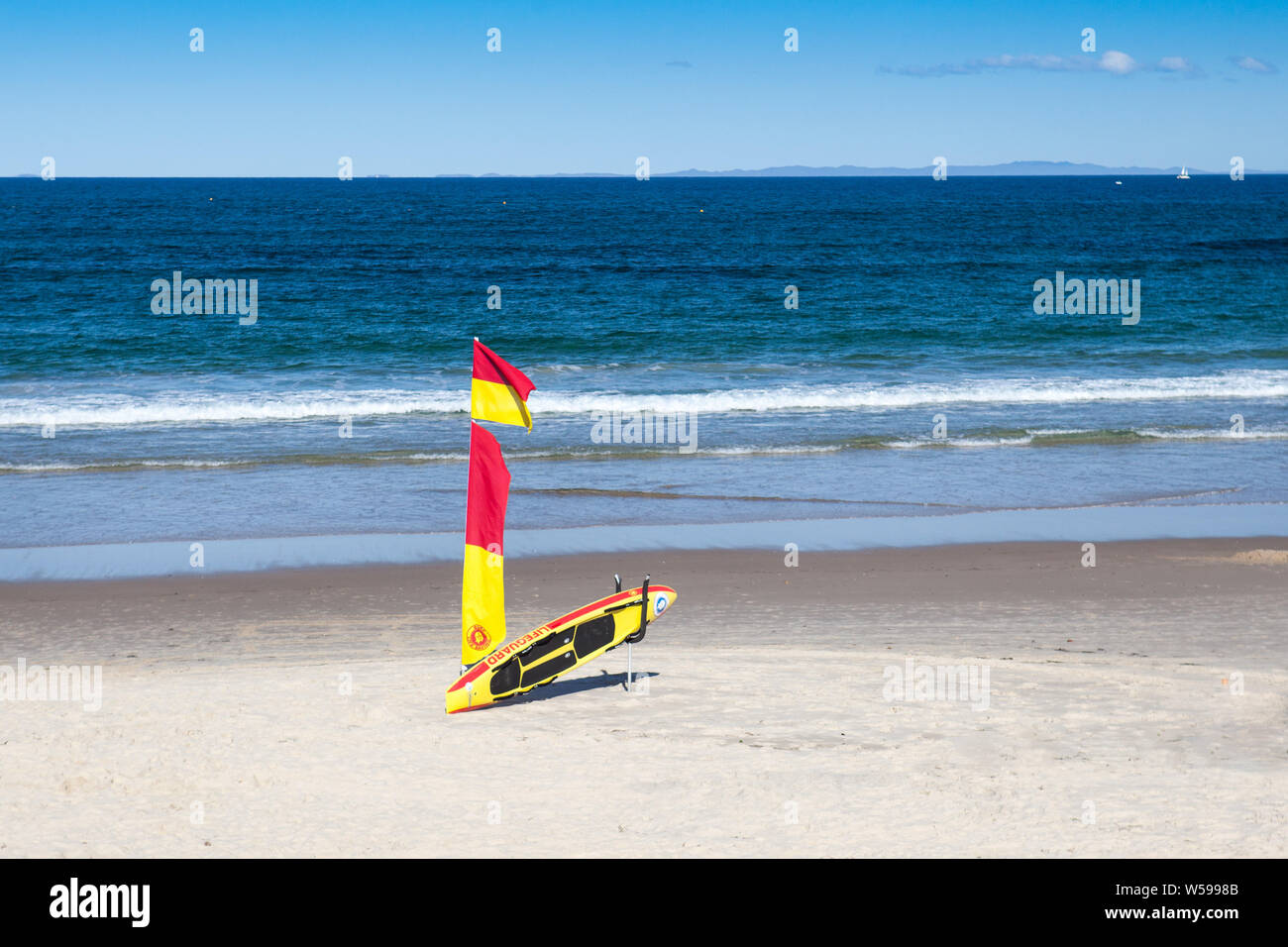 Familiar red and yellow lifeguard flags flying on a beach in Australia ...