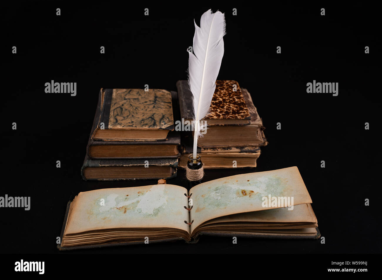 Feathers of birds for writing and calligraphy on old paper. A place for ...