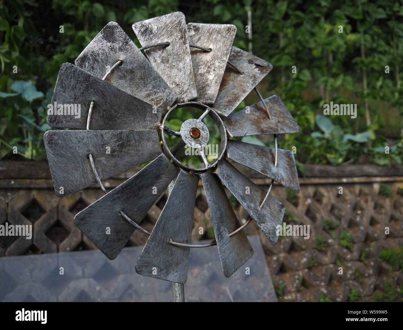 Metal pinwheel decoration in a garden Stock Photo - Alamy