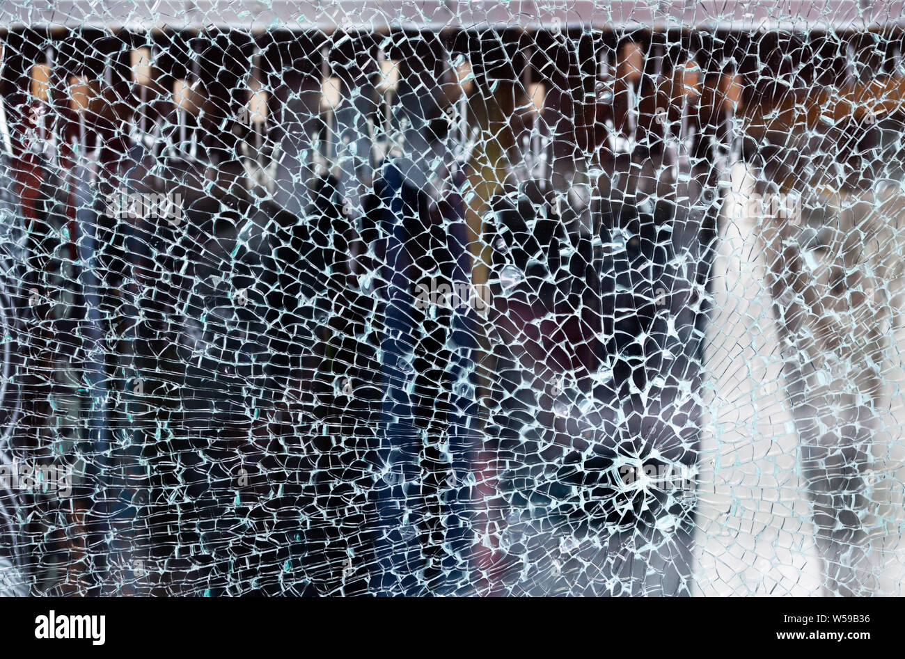Broken glass of a shop window of a clothing store with unfocused ...