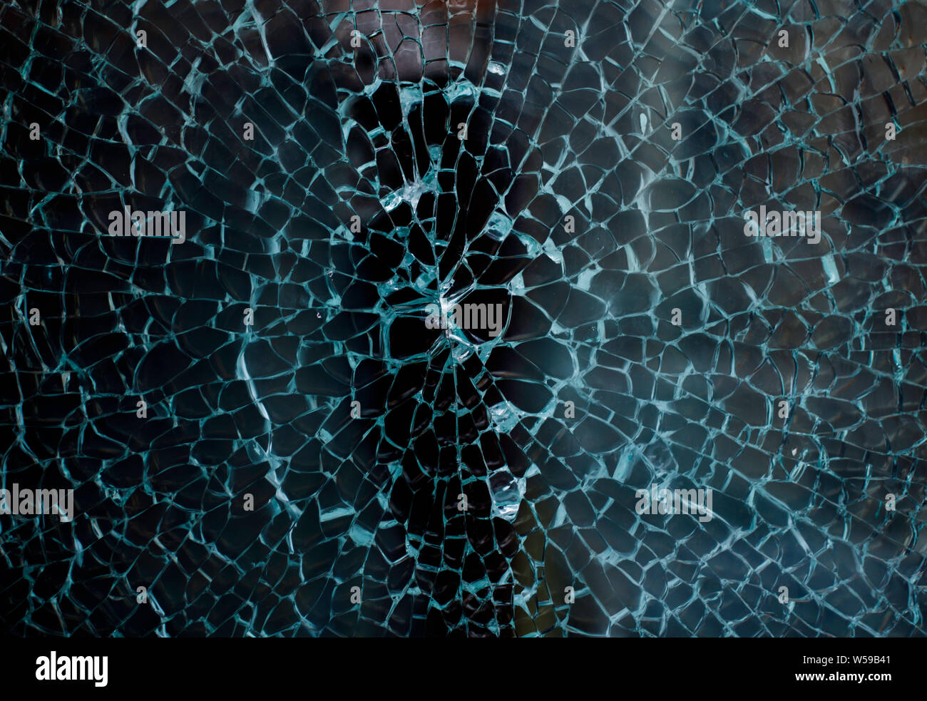 Broken glass of a shop window of a clothing store with unfocused ...