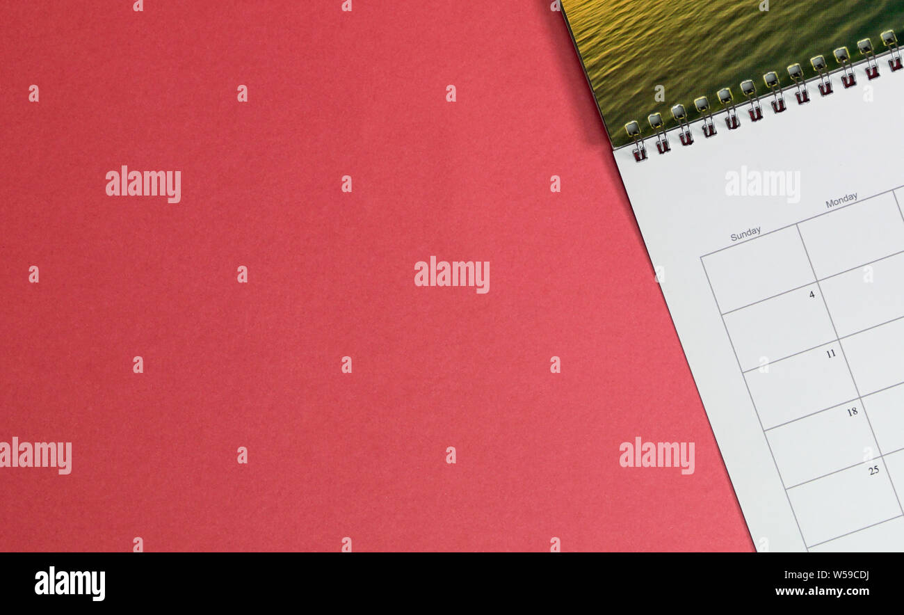 Calendar or planner on red background with copy space. Business ...