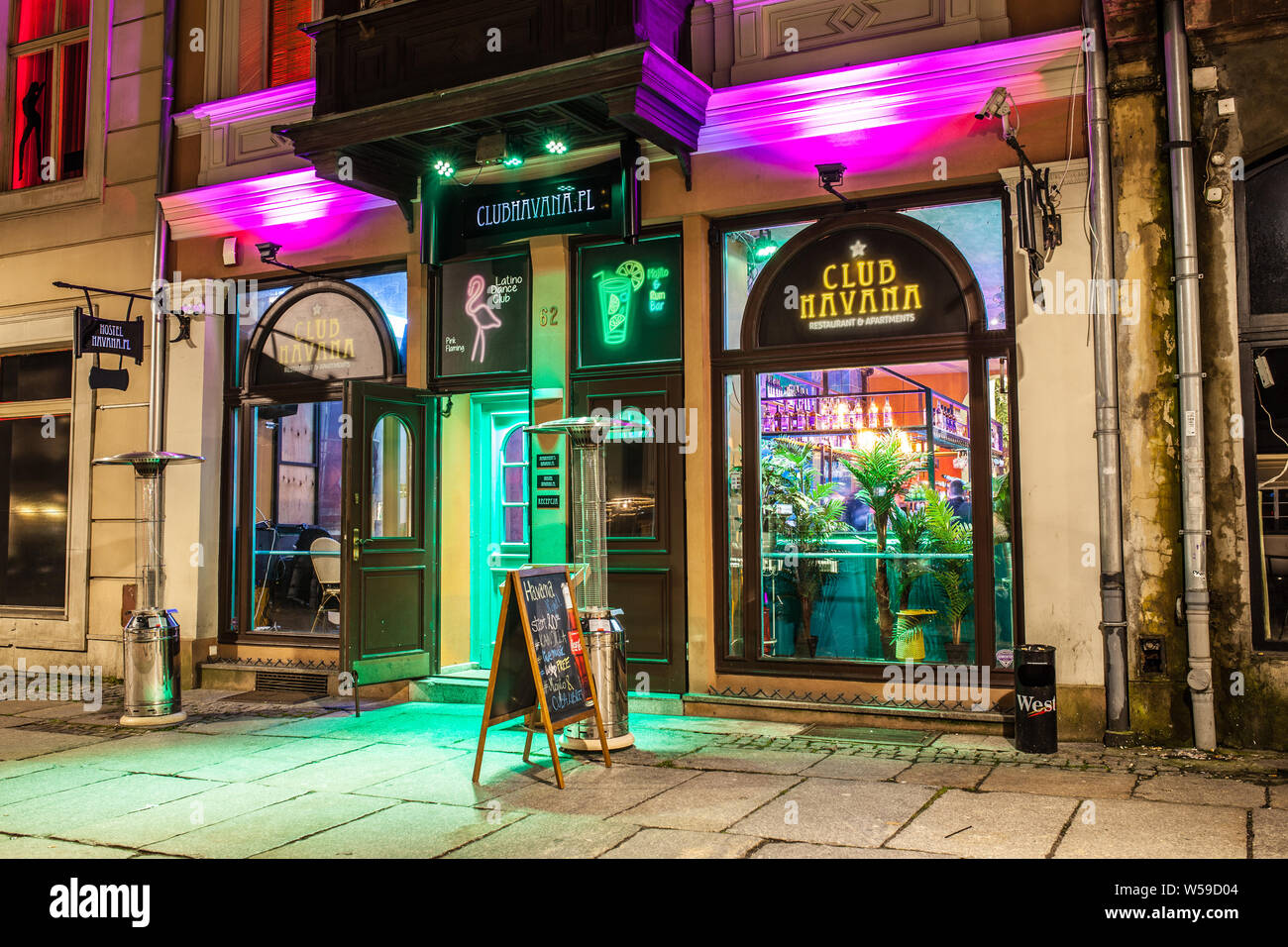 Poznan, Poland, Nov 2017: old Market Square at night, restaurant, bar ...