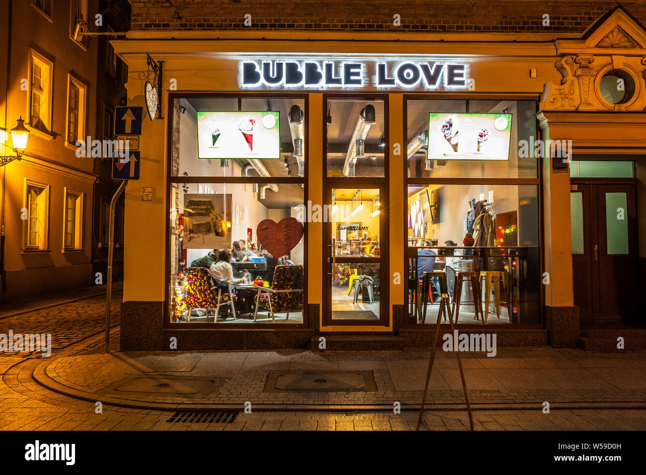 Poznan, Poland, Nov 2017: old Market Square at night, restaurant, bar ...