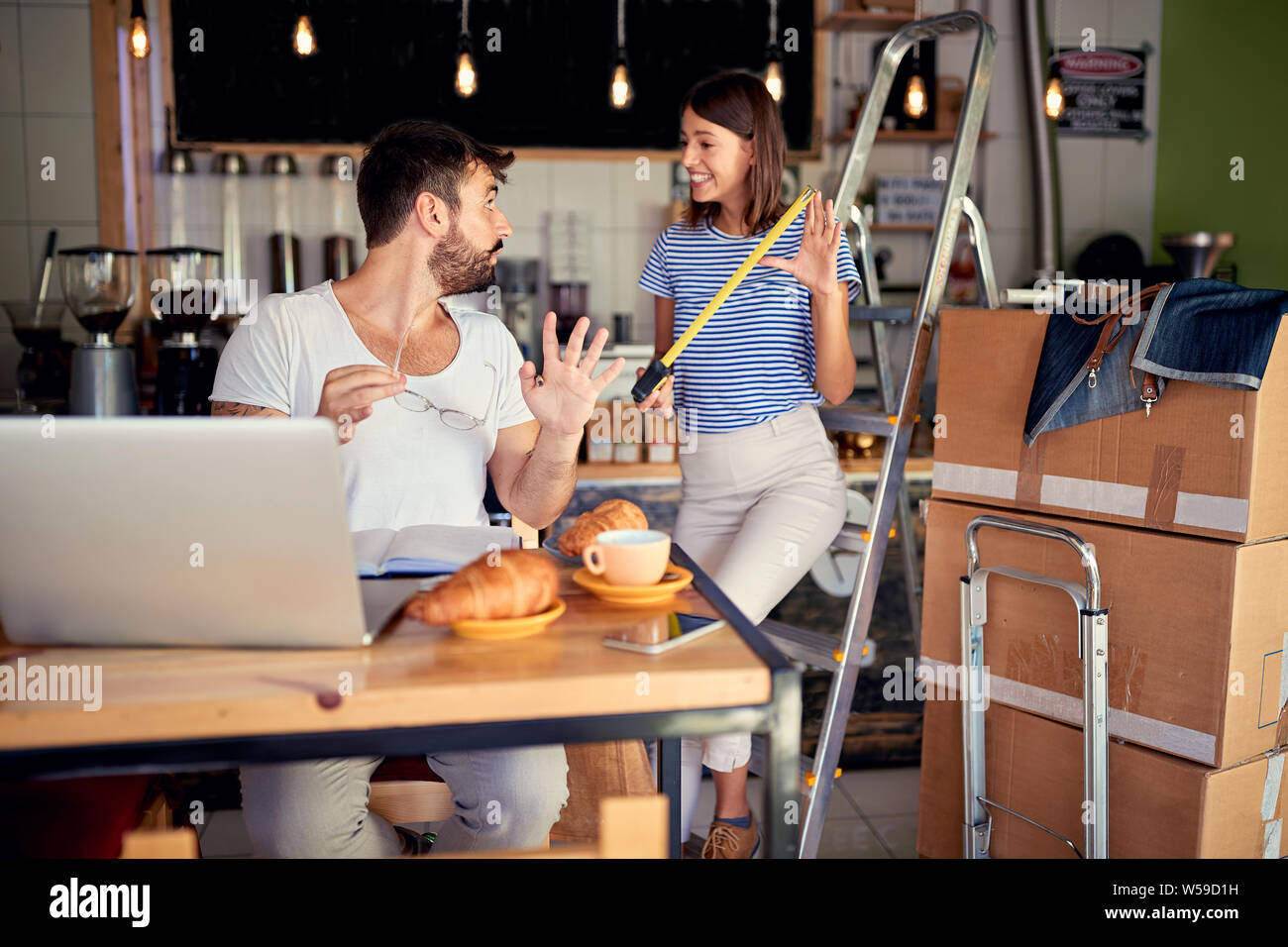Happy two small business owner ready to open their cafe Stock Photo - Alamy