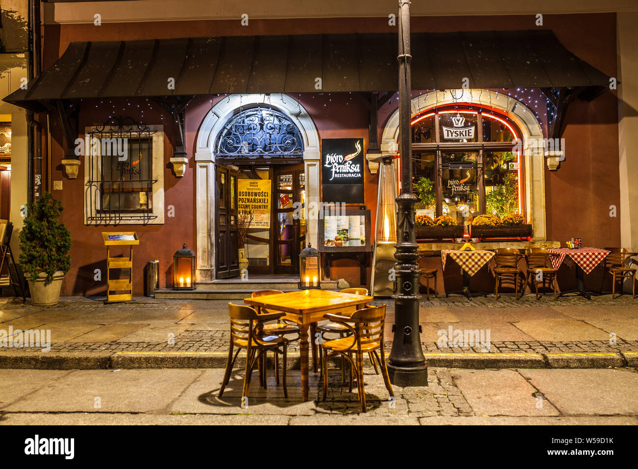 Poznan, Poland, Nov 2017: old Market Square at night, restaurant, bar ...