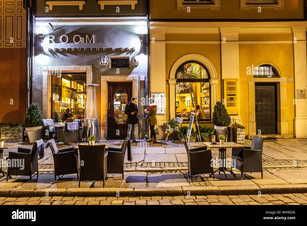 Poznan, Poland, Nov 2017: old Market Square at night, restaurant, bar ...
