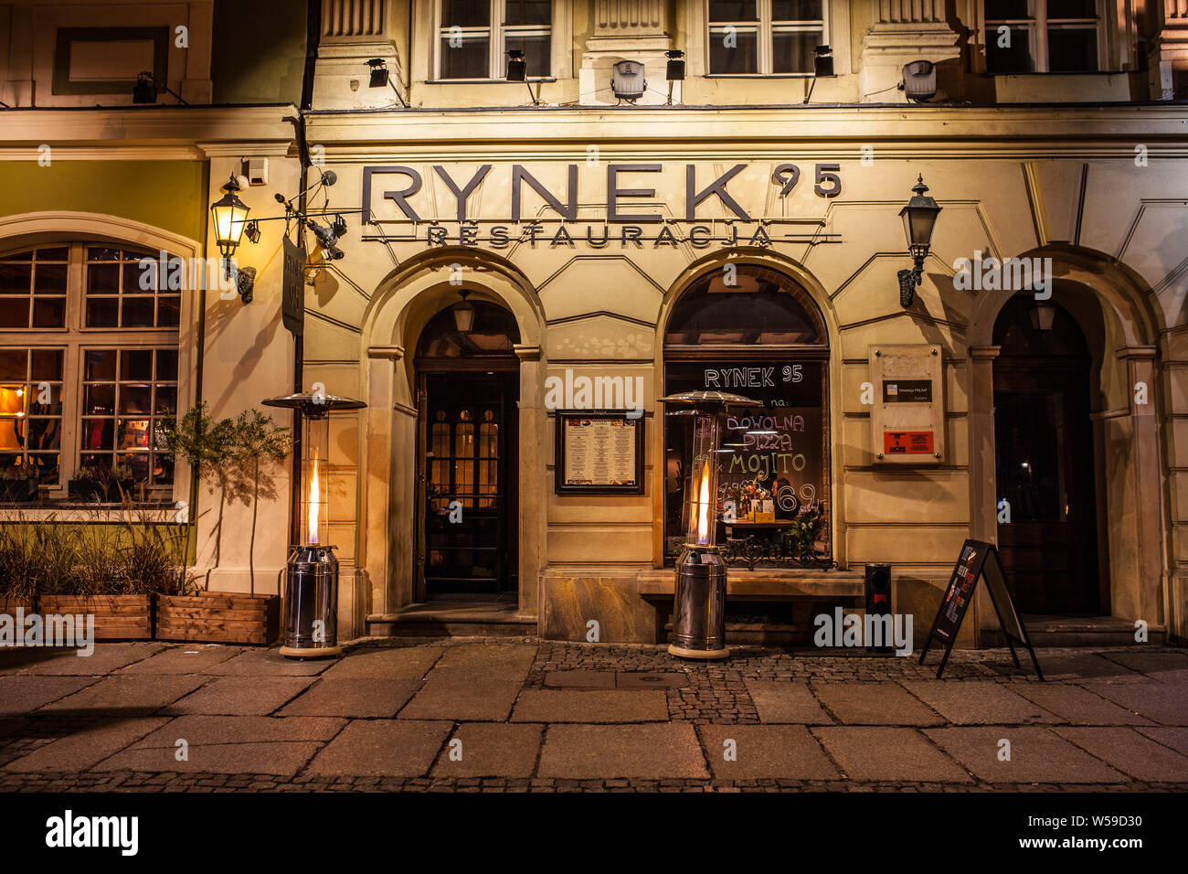 Poznan, Poland, Nov 2017: old Market Square at night, restaurant, bar ...
