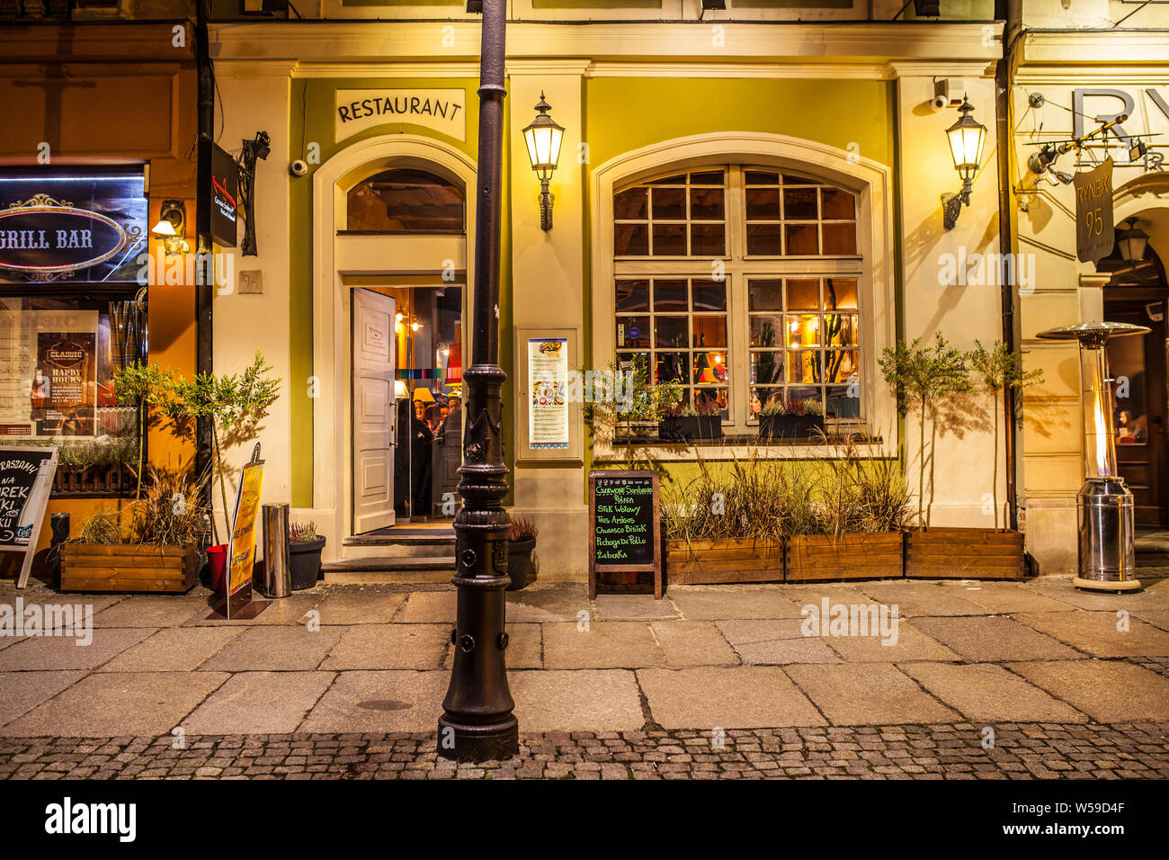 Poznan, Poland, Nov 2017: old Market Square at night, restaurant, bar ...