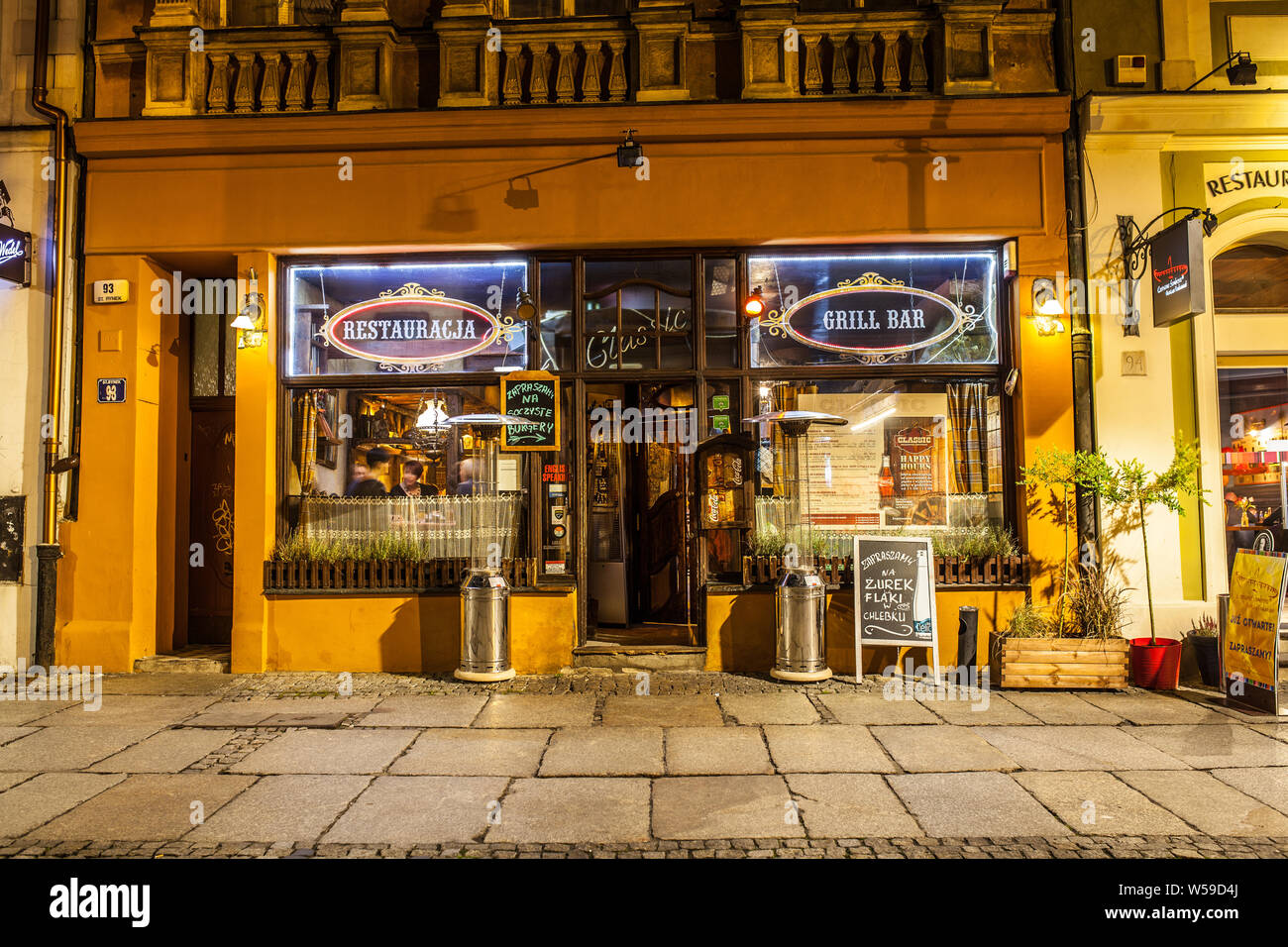 Poznan, Poland, Nov 2017: old Market Square at night, restaurant, bar ...