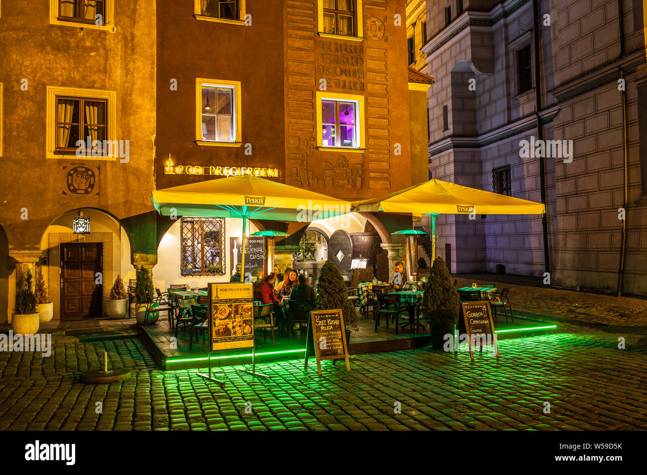 Poznan, Poland, Nov 2017: old Market Square at night, restaurant, bar ...