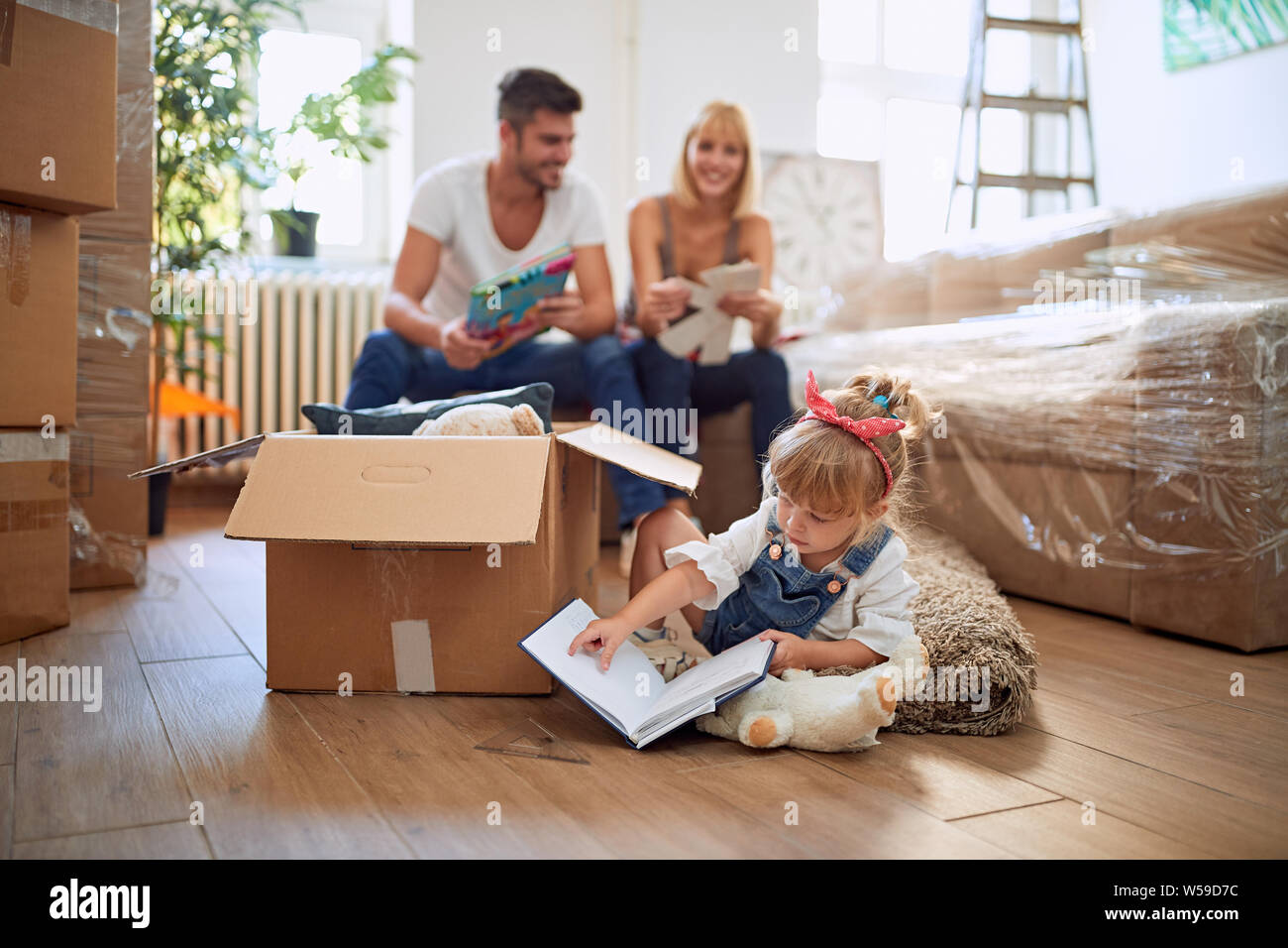 little cute girl with cardboard boxes in new home Stock Photo - Alamy