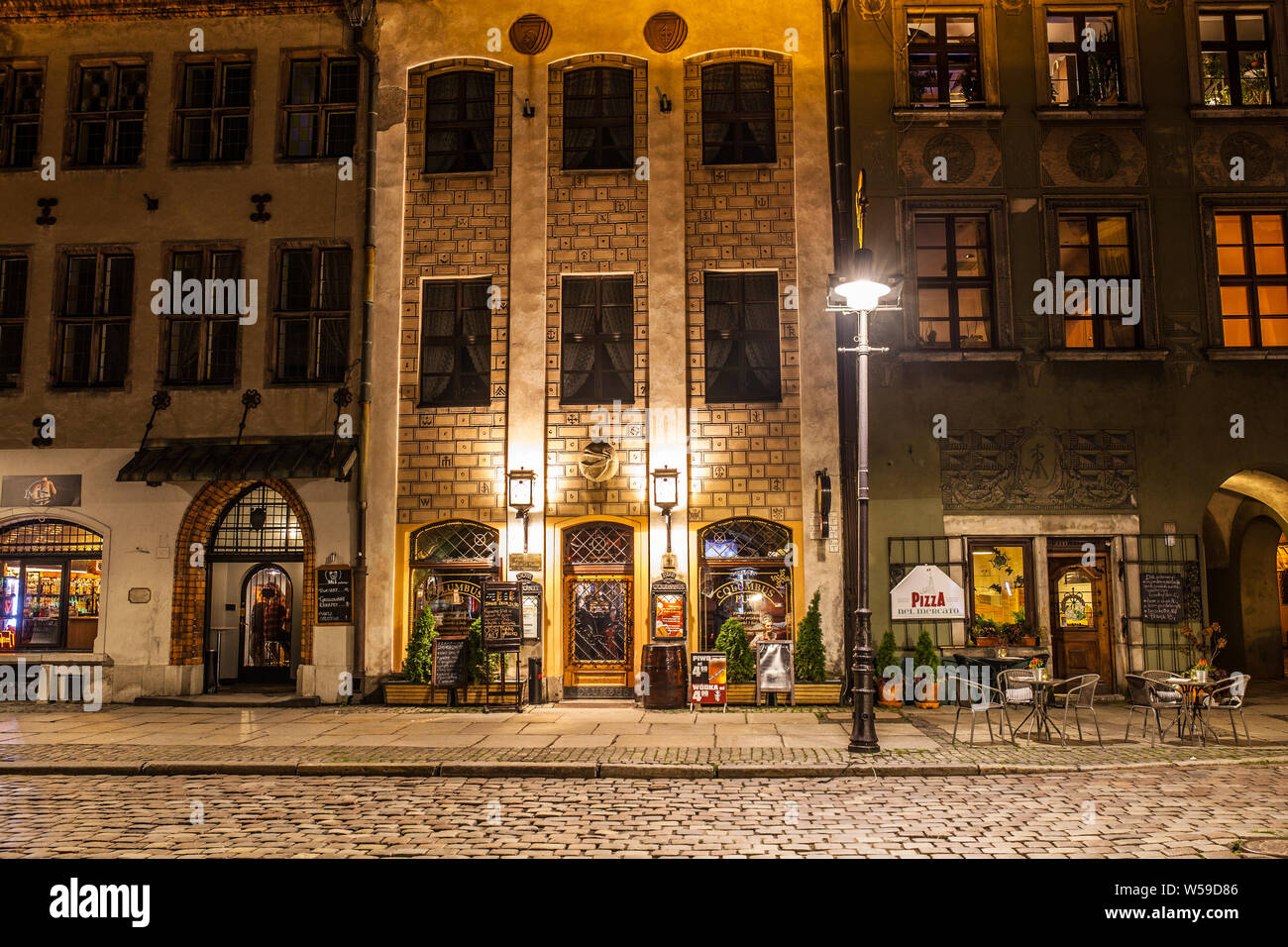 Poznan, Poland, Nov 2017: old Market Square at night, restaurant, bar ...