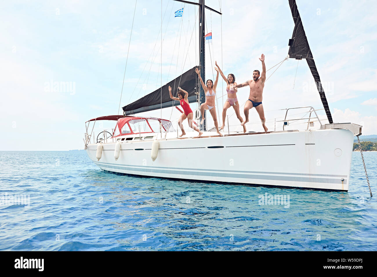 Young man jumping from boat hi-res stock photography and images - Alamy