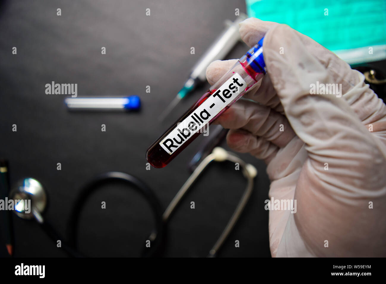 Rubella - Test with blood sample. Top view isolated on black background ...