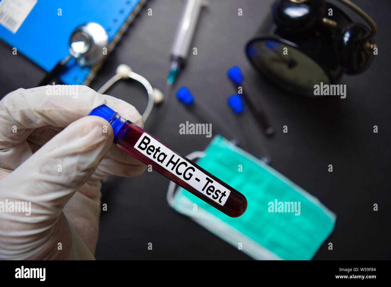 Beta HCG - Test with blood sample. Top view isolated on black ...