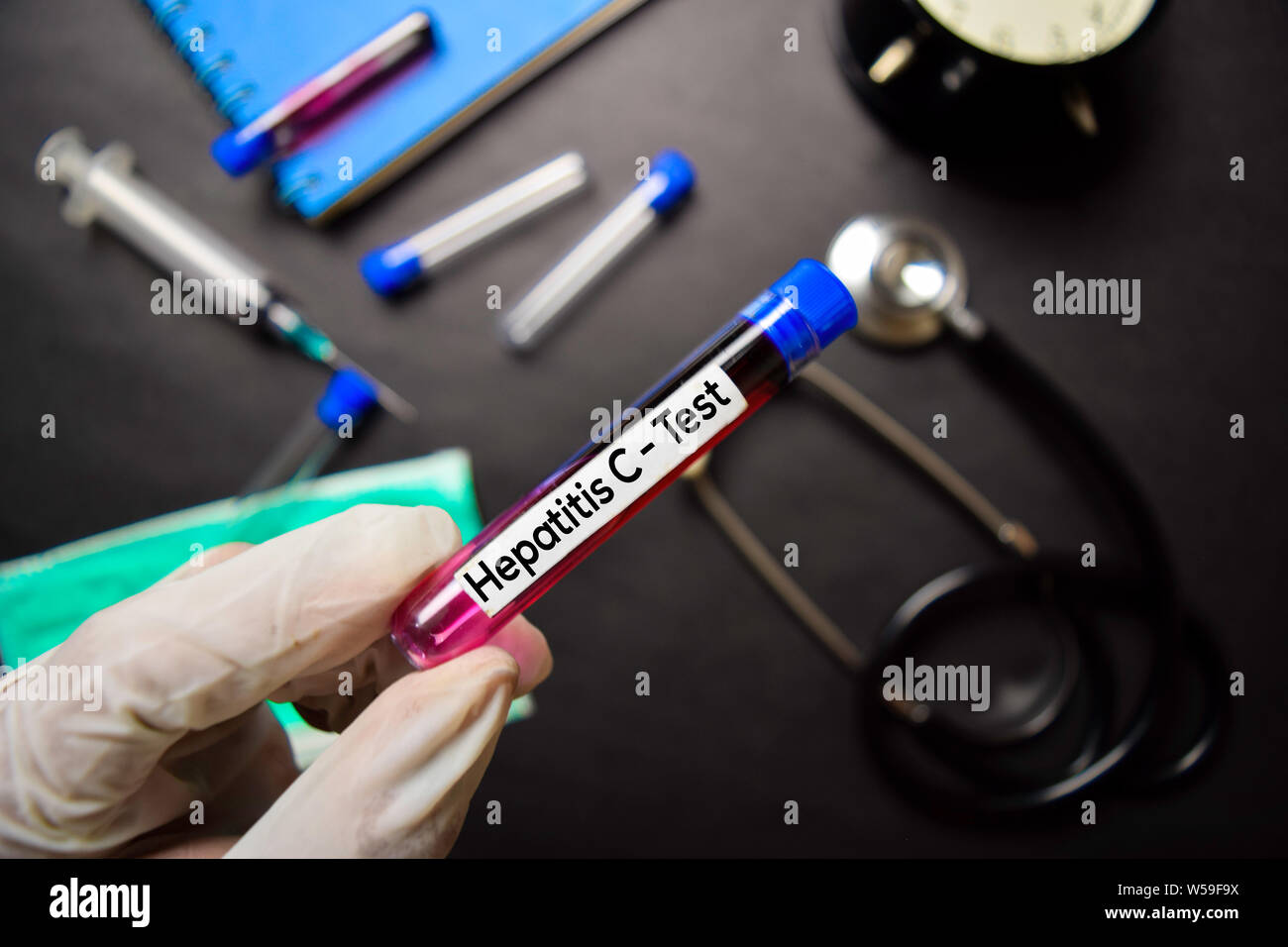 Hepatitis C - Test with blood sample. Top view isolated on black ...