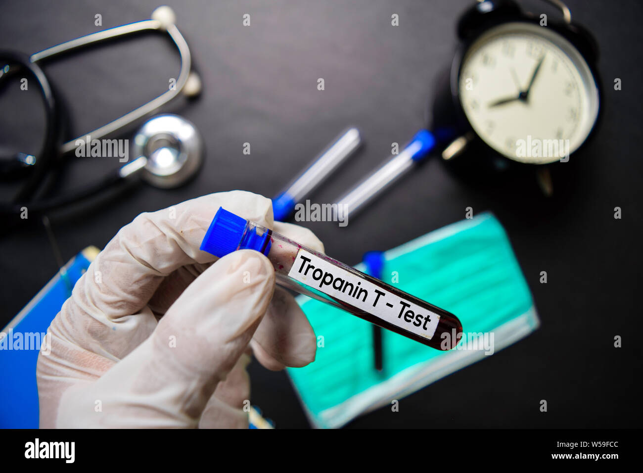 Tropanin T - Test with blood sample. Top view isolated on black ...