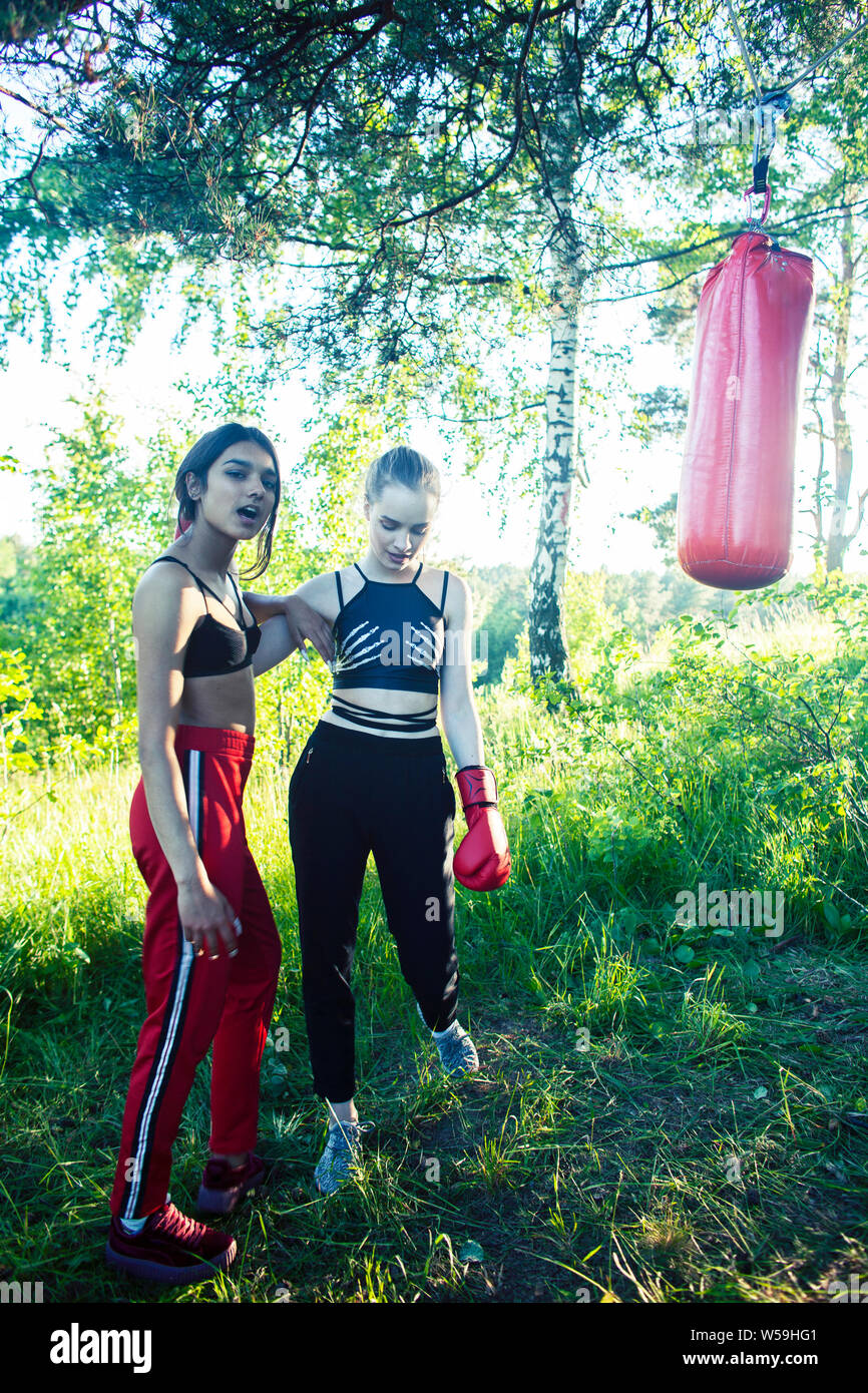 Two Diverse Nations Girls Fighting Boxing Outside In Green Park Sport Summer People Concept