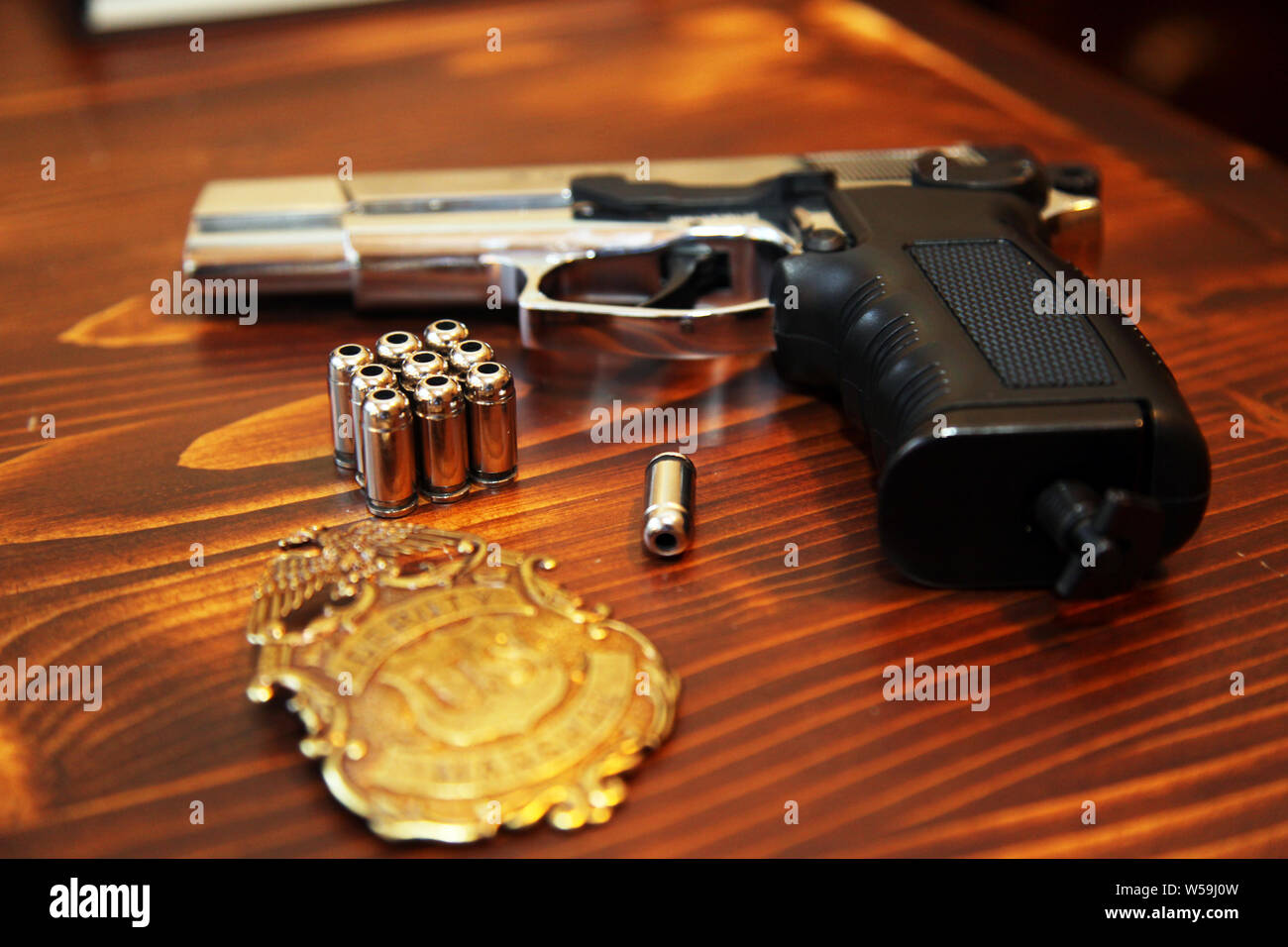 Gun, bullets and police badge Stock Photo - Alamy