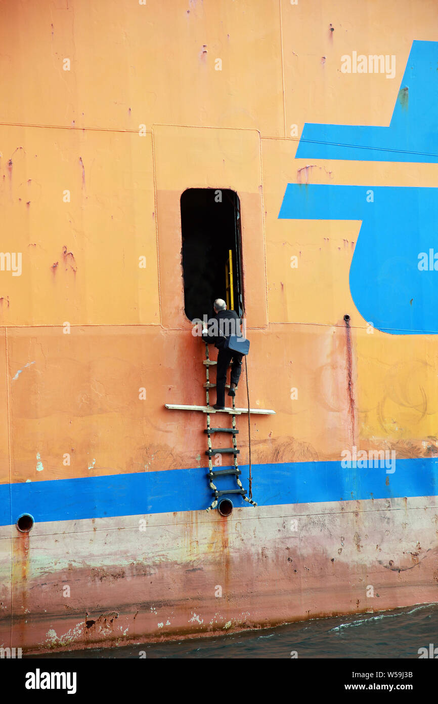 Sea Guide Captain coming in industrial ship Stock Photo - Alamy