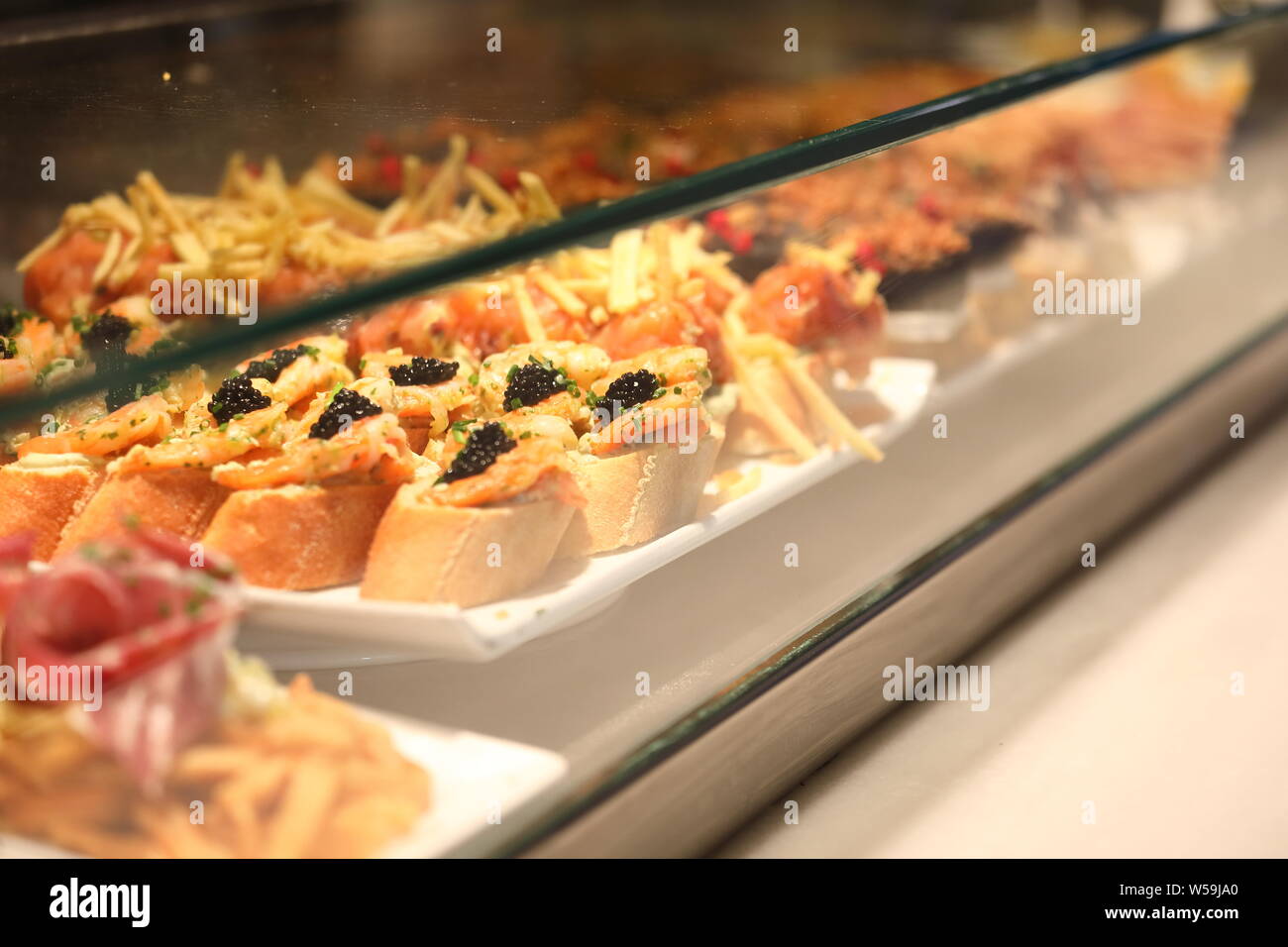 Spanish food restaurant tapas display Stock Photo - Alamy