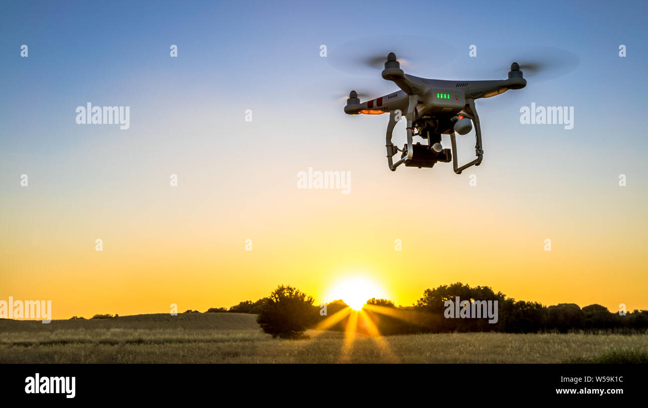 Aerial view of drone flying with a digital camera over a field with ...