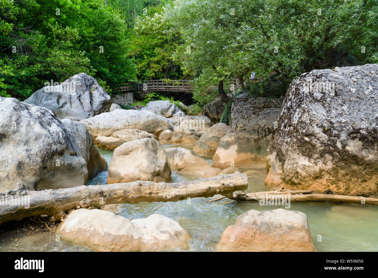 Stone formation near Ilica waterfalls and wooden bridge in background ...
