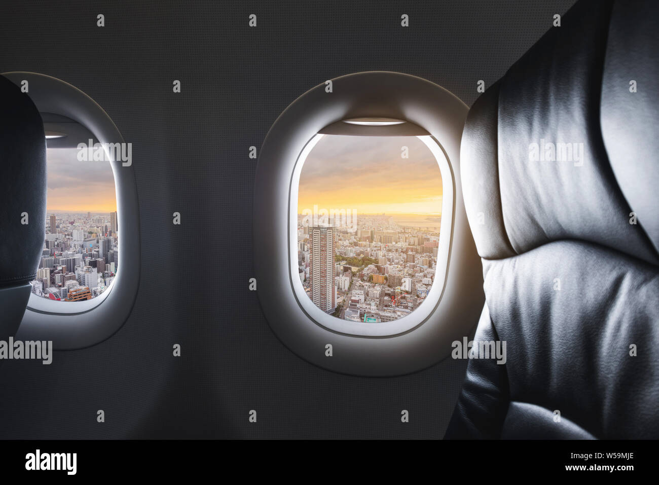 Looking through airplane window with aerial view of Osaka city in Japan ...