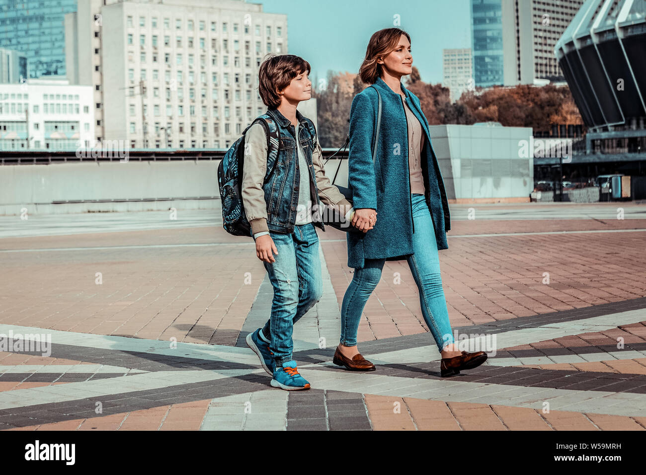 Proud parent. Kind boy keeping smile on his face while spending time ...