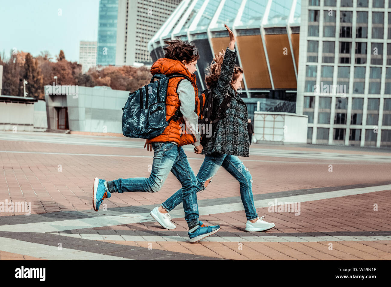 Follow us. Active boy jumping while following his friend Stock Photo ...