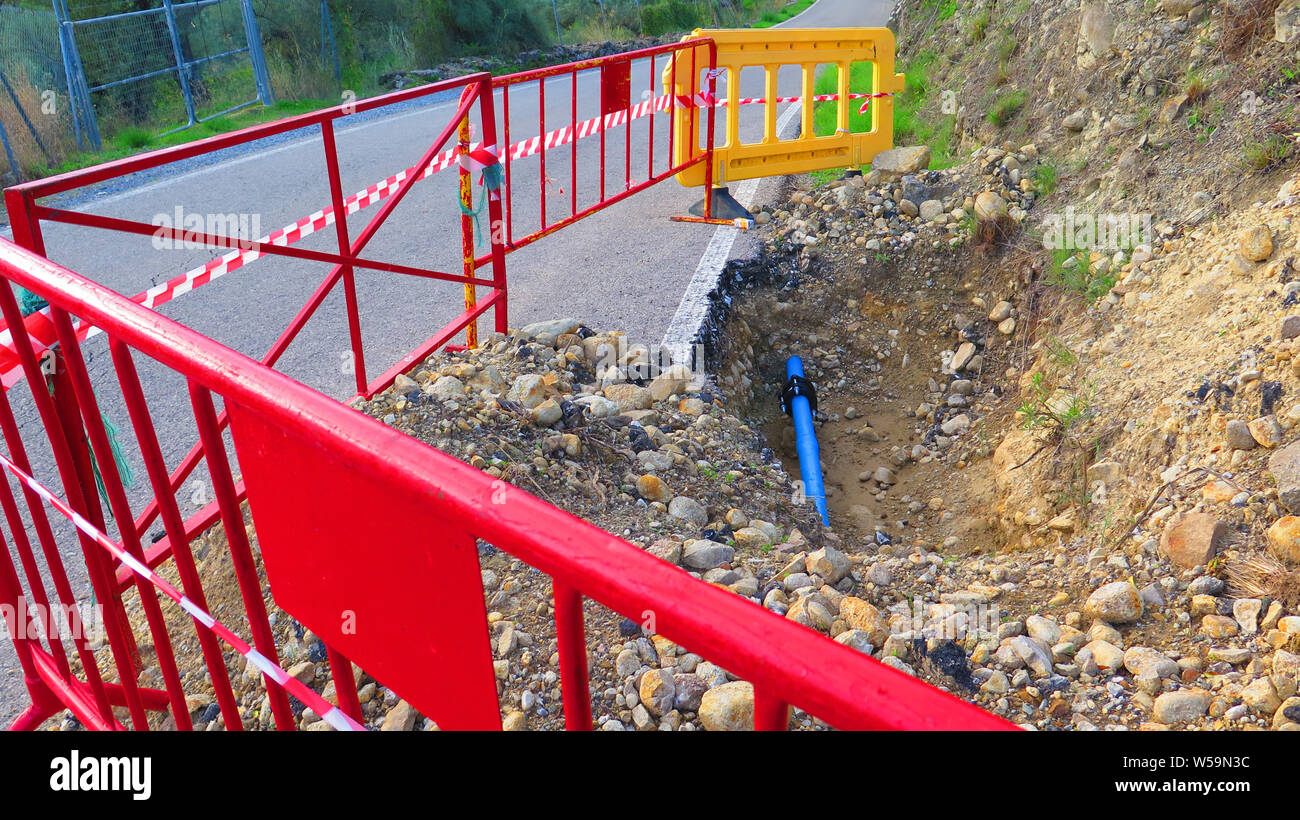 Fenced of roadside exposed pipe repair site on Andalusian country road ...