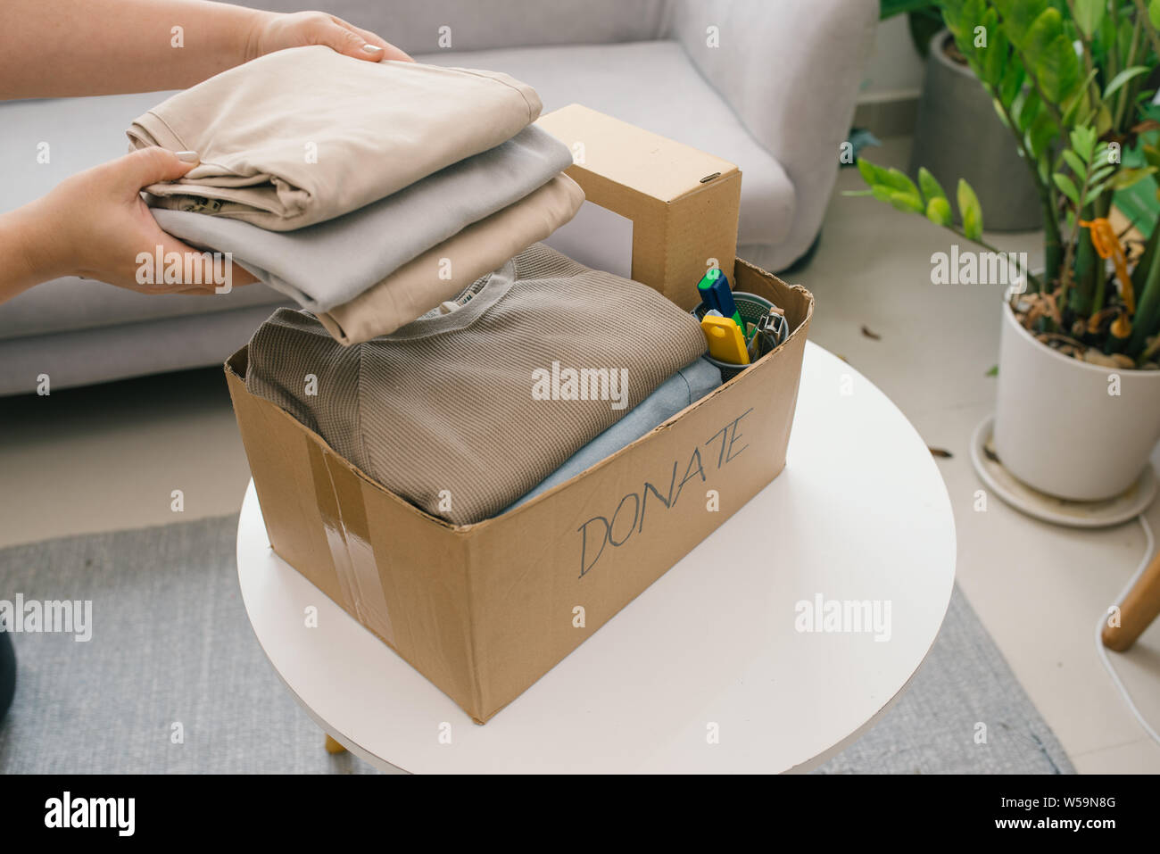 People putting clothes inside hi-res stock photography and images - Alamy