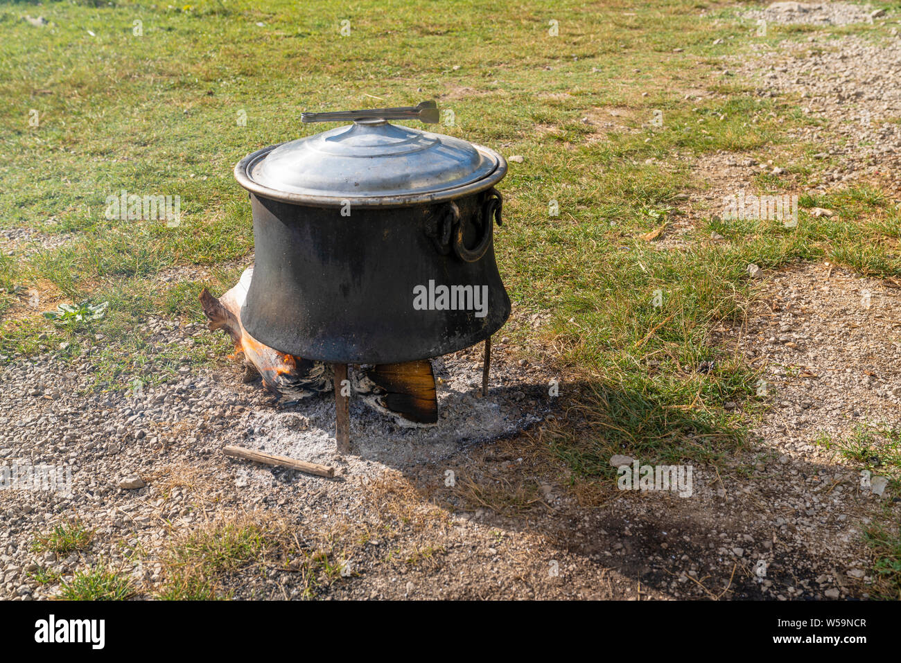 Big copper pot (kazan) on flame. Kazan was popular to boil water and ...