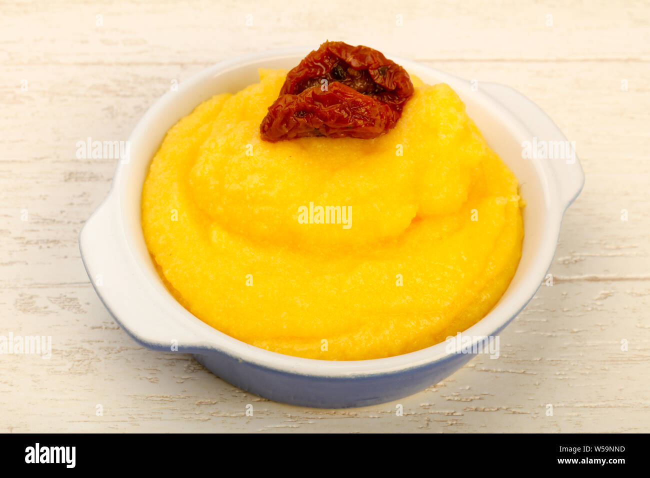 Polenta with dry tomato Stock Photo - Alamy