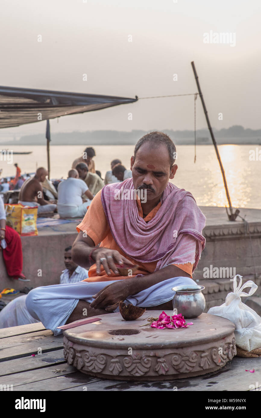 A guru performing a hindu ceremony to local pilgrims at the Ganges ...