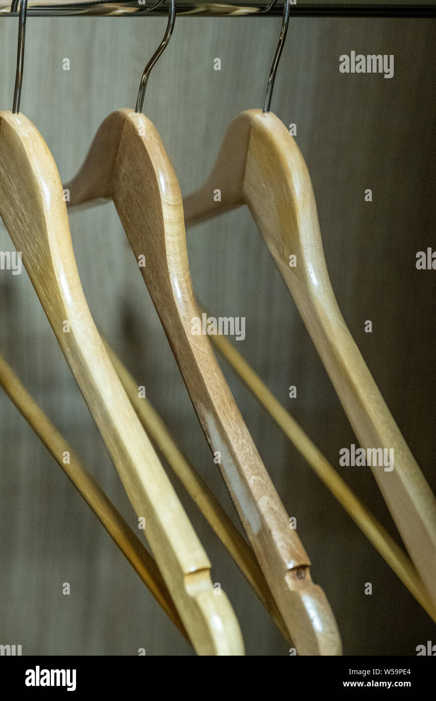 three empty wooden hangers in the closet Stock Photo - Alamy