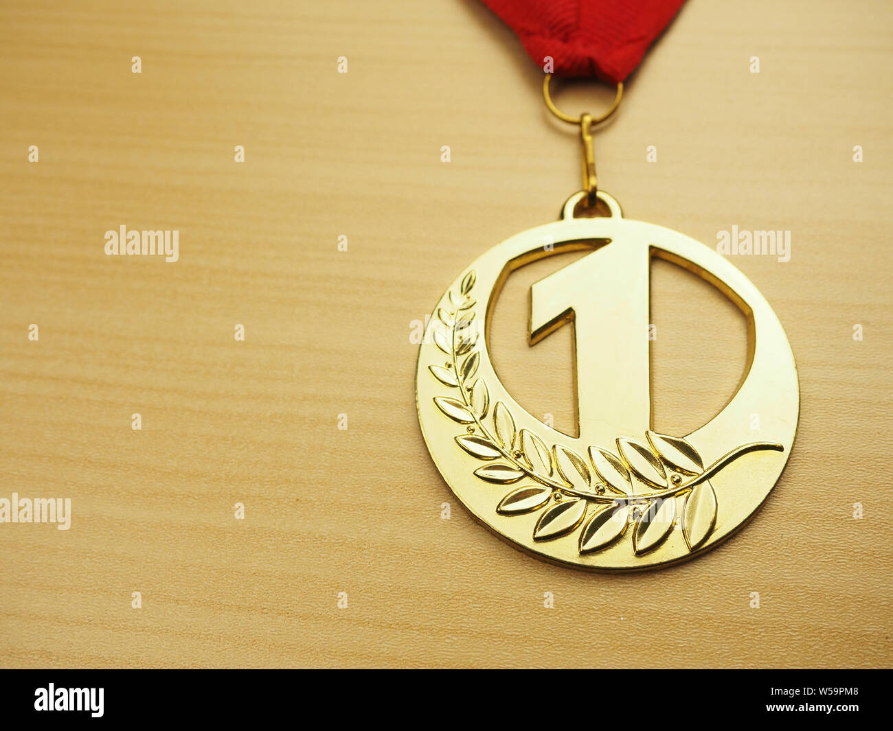 Gold first place winners medal. Success achievement concept Stock Photo ...